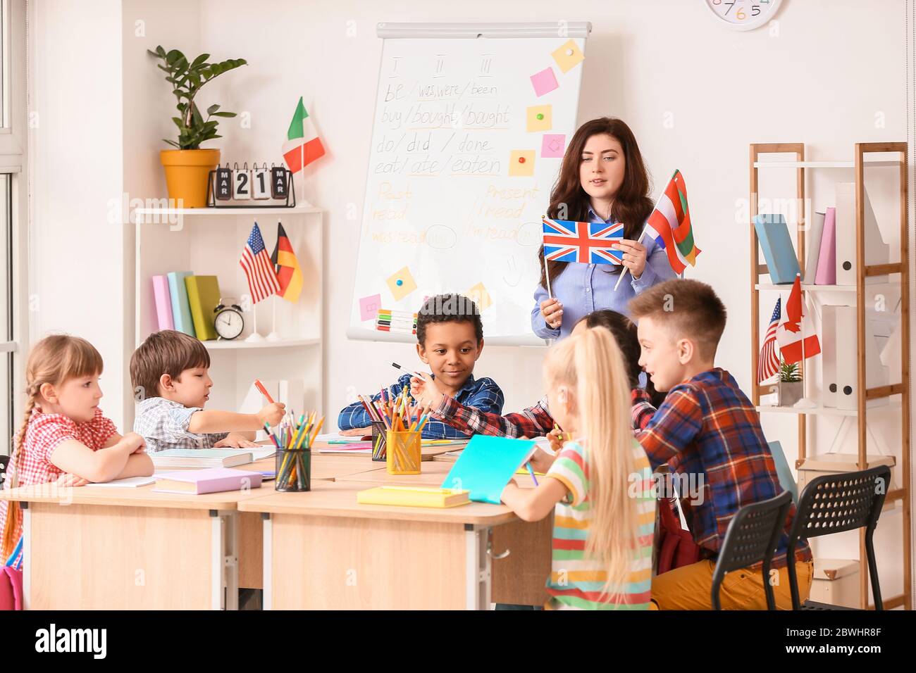 Teacher conducting lesson for little children at language school Stock ...