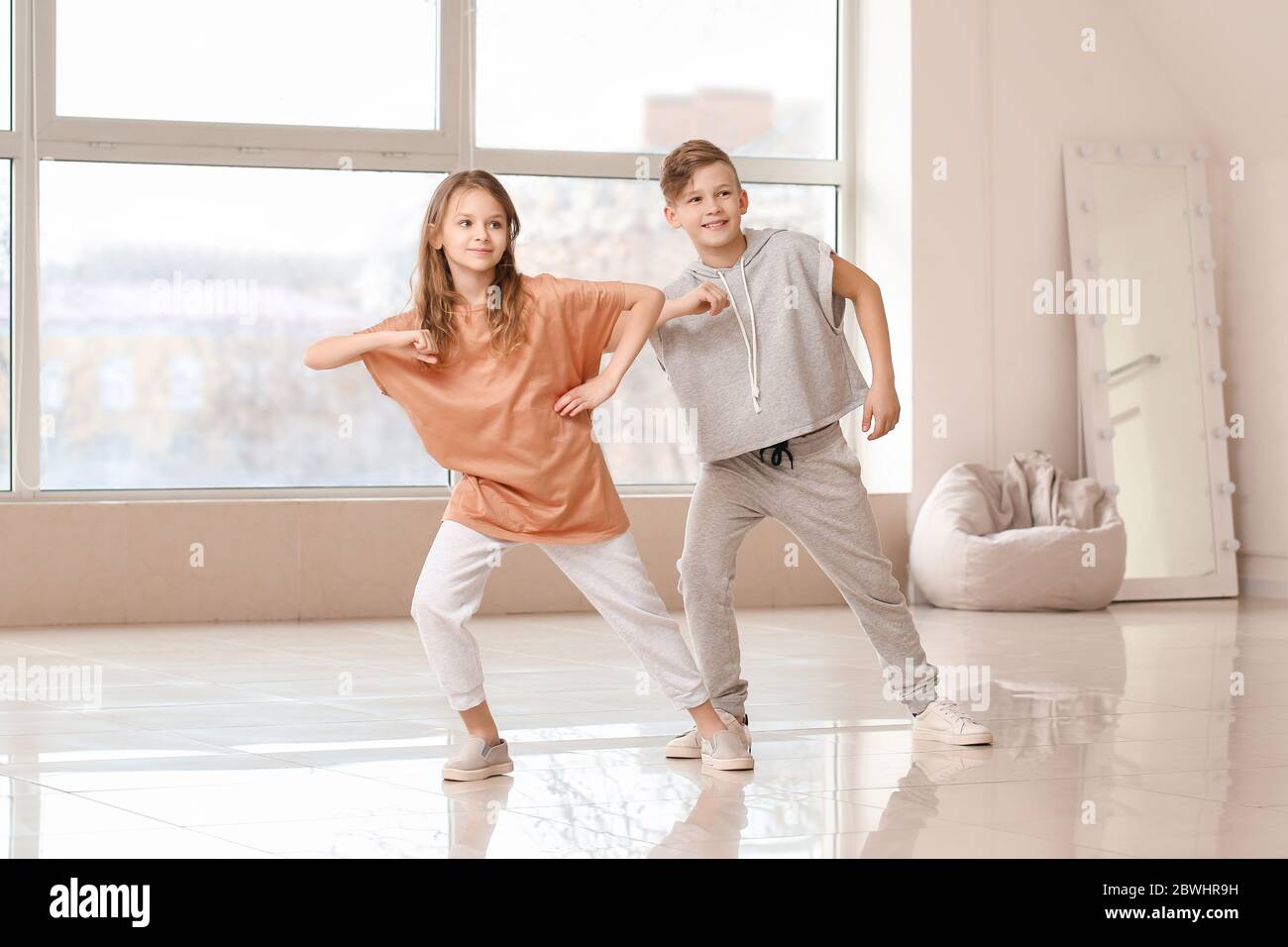 Cute little children dancing in studio Stock Photo - Alamy
