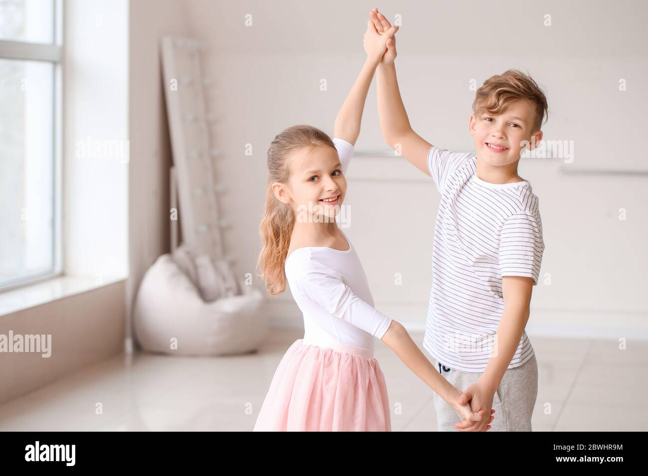 Cute little children dancing in studio Stock Photo - Alamy