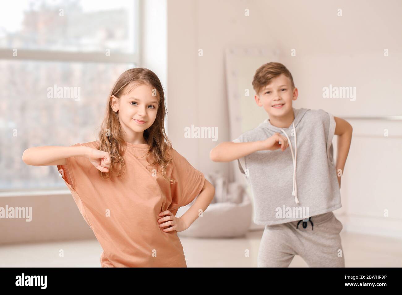 Cute little children dancing in studio Stock Photo - Alamy