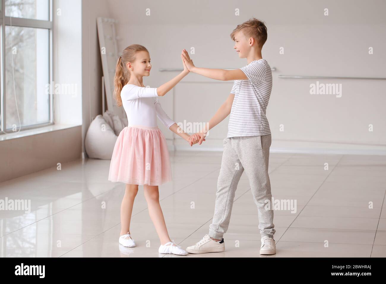 Cute little children dancing in studio Stock Photo - Alamy