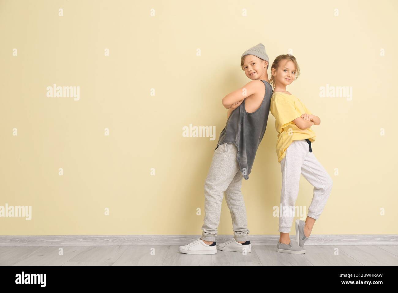 Cute little children dancing against color wall Stock Photo - Alamy