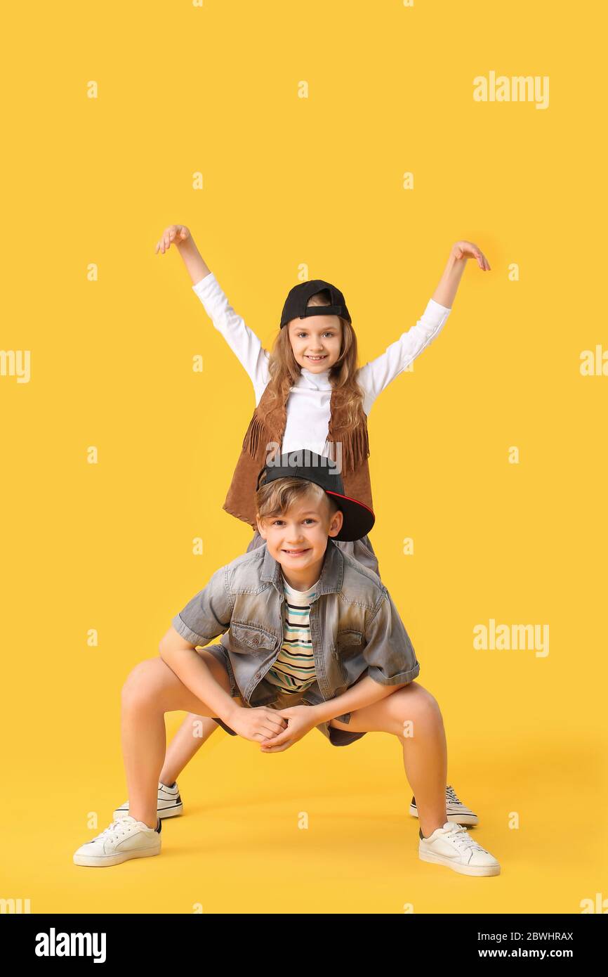 Cute little children dancing against color background Stock Photo - Alamy