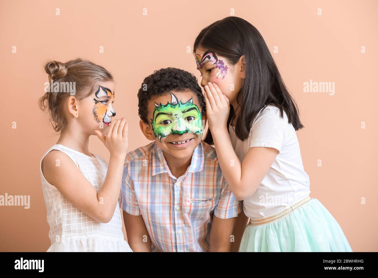 Funny children with face painting on color background Stock Photo - Alamy