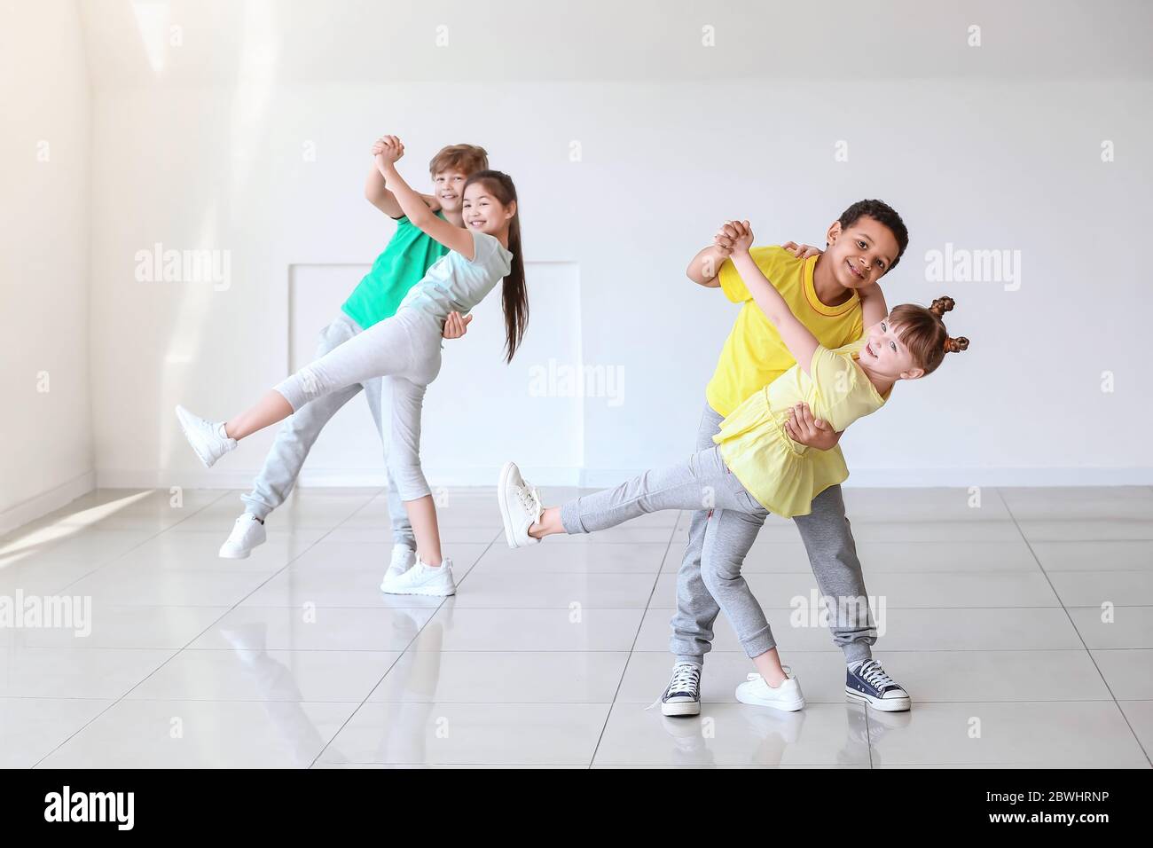 Cute little children dancing in studio Stock Photo - Alamy
