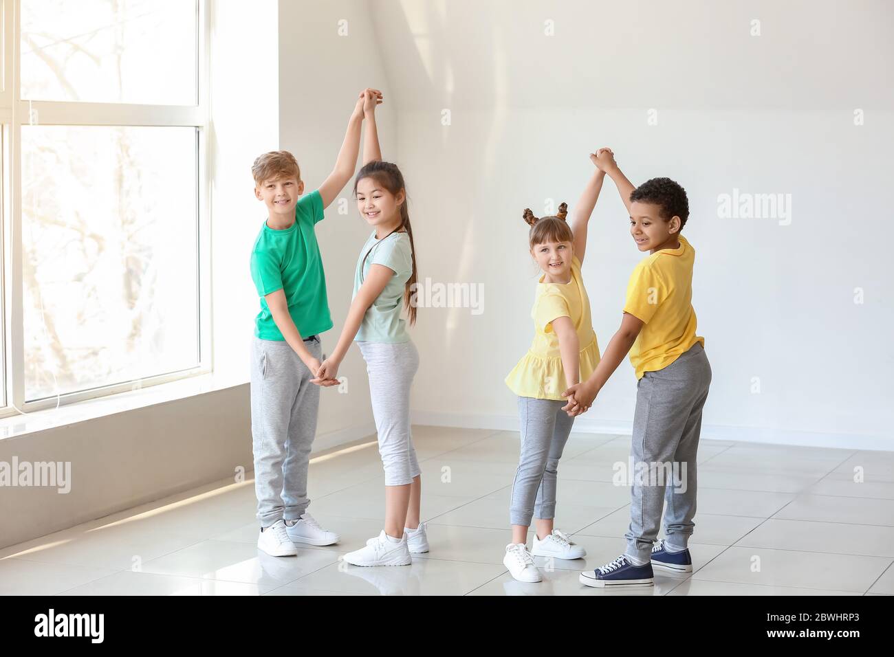 Cute little children dancing in studio Stock Photo - Alamy