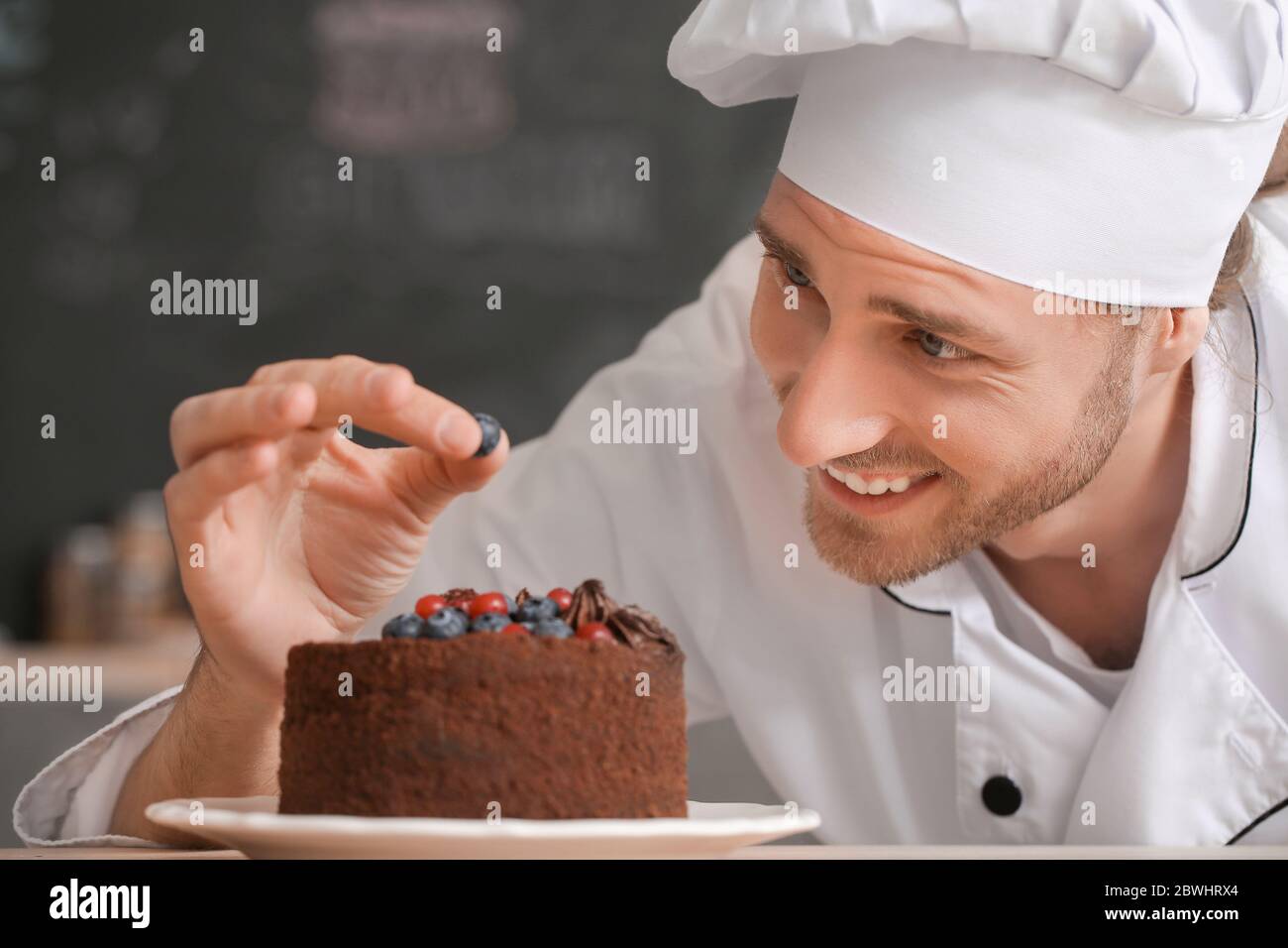 Male confectioner decorating tasty hi-res stock photography and images ...