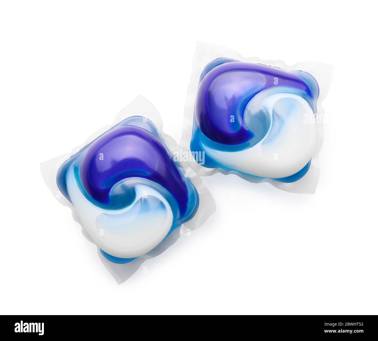 Capsules with laundry detergent on color background Stock Photo - Alamy