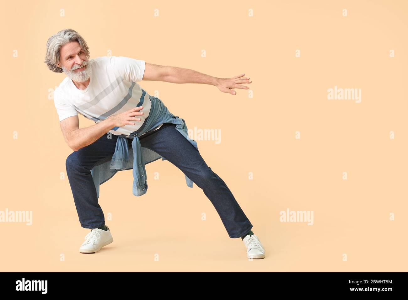 Cool senior man dancing against color background Stock Photo - Alamy