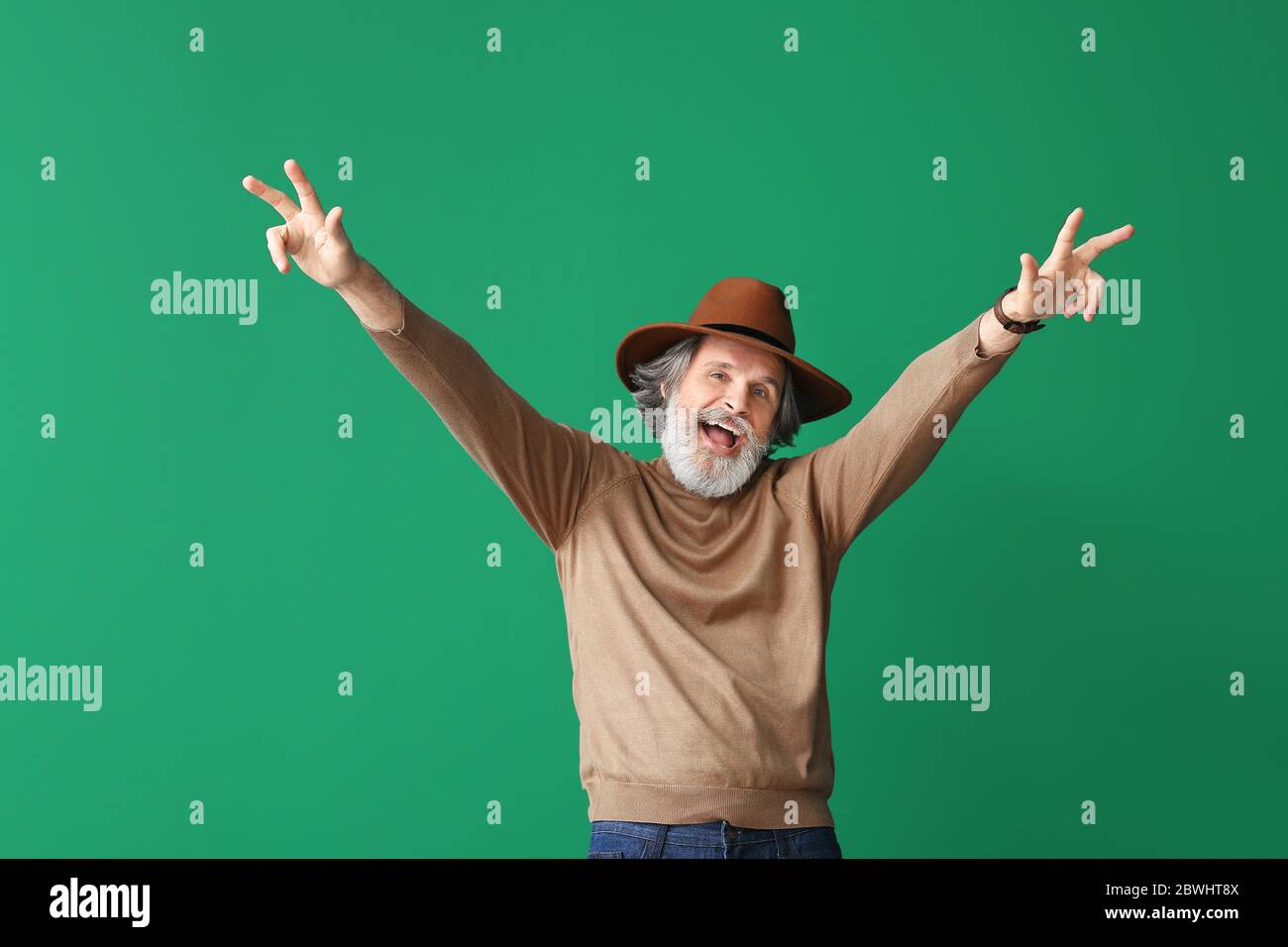 Cool senior man dancing against color background Stock Photo - Alamy