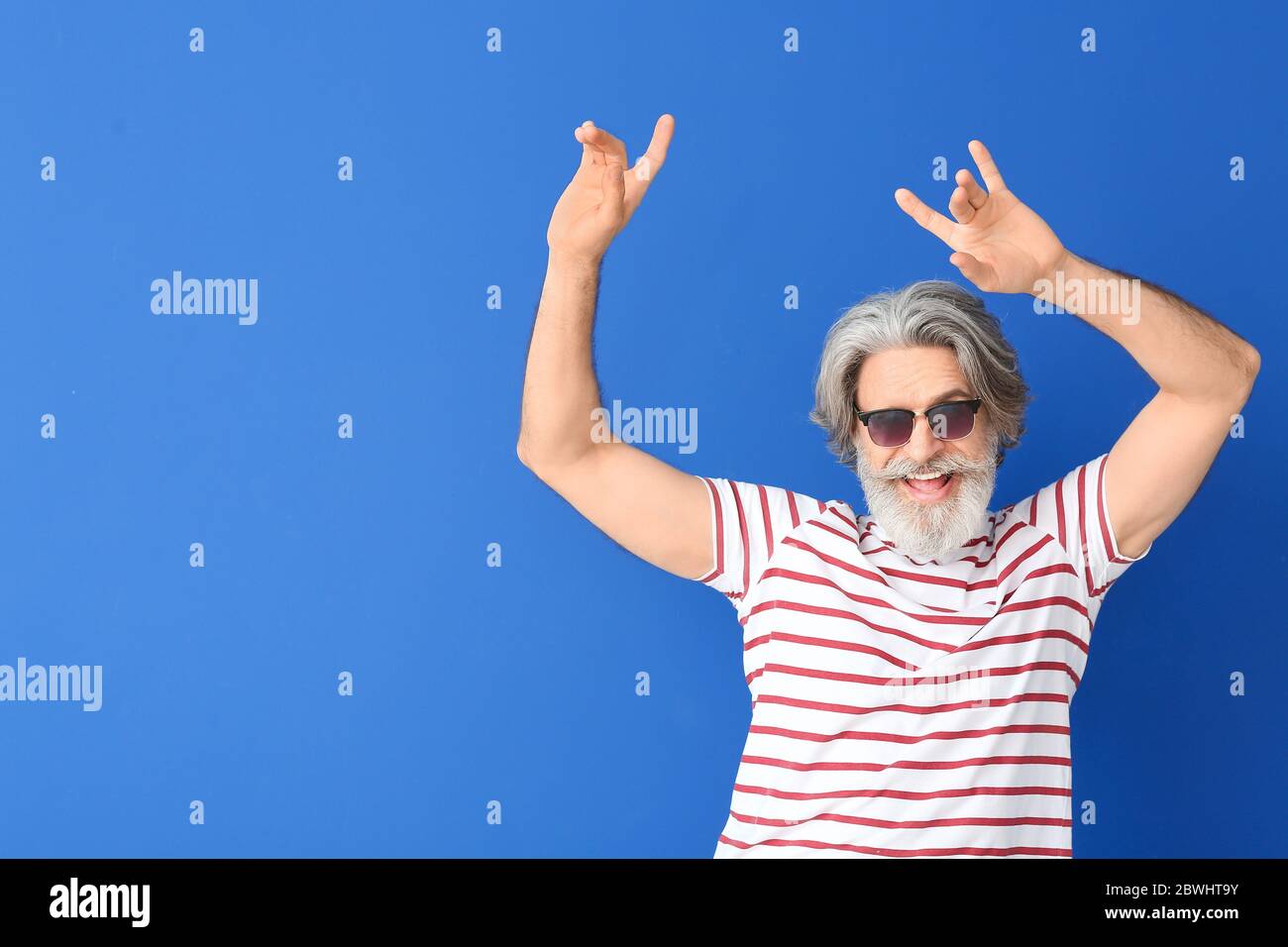 Cool senior man dancing against color background Stock Photo - Alamy