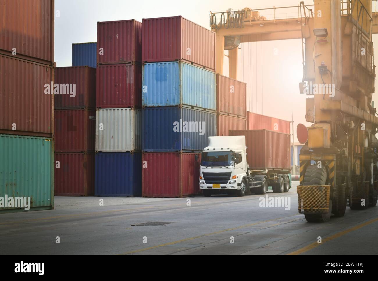 Truck loading container from RTG at a container yard, container ...