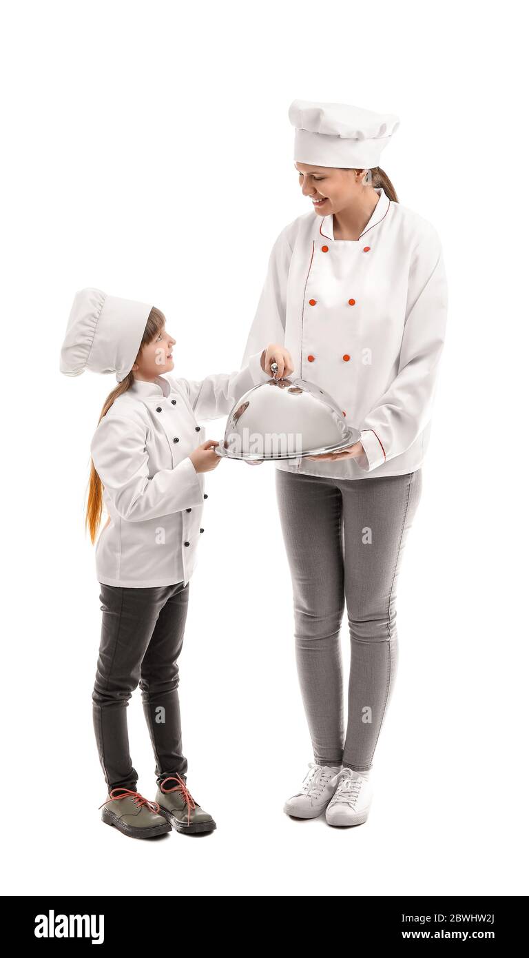 Portrait of female chef and her little daughter on white background ...