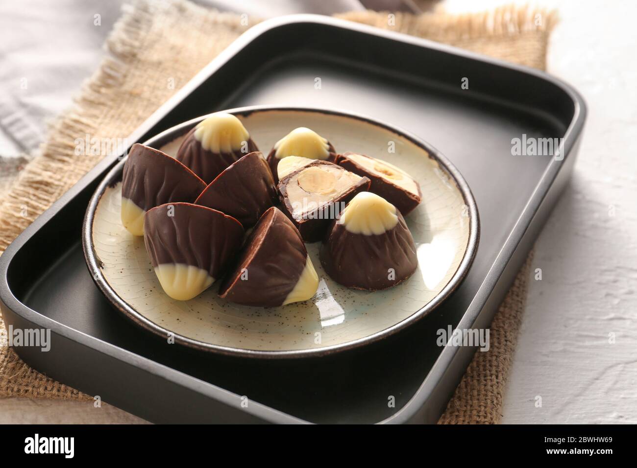 Plate with tasty chocolate candies on white background Stock Photo - Alamy