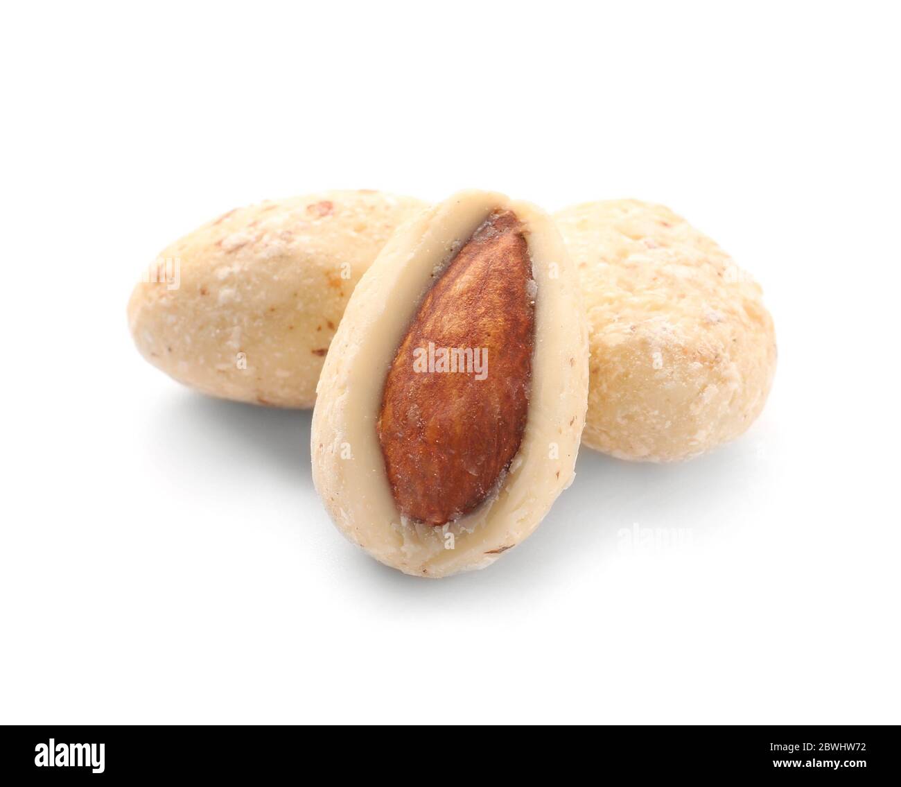Tasty coated nuts on white background Stock Photo - Alamy