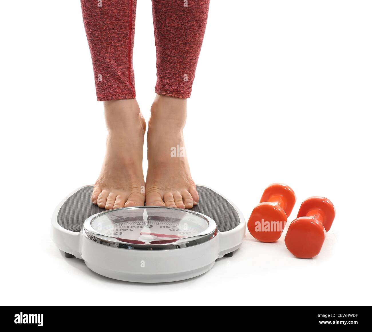 Young woman measuring her weight on white background Stock Photo - Alamy