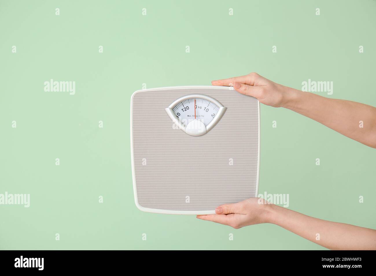 Female hands with measuring scales on color background Stock Photo - Alamy