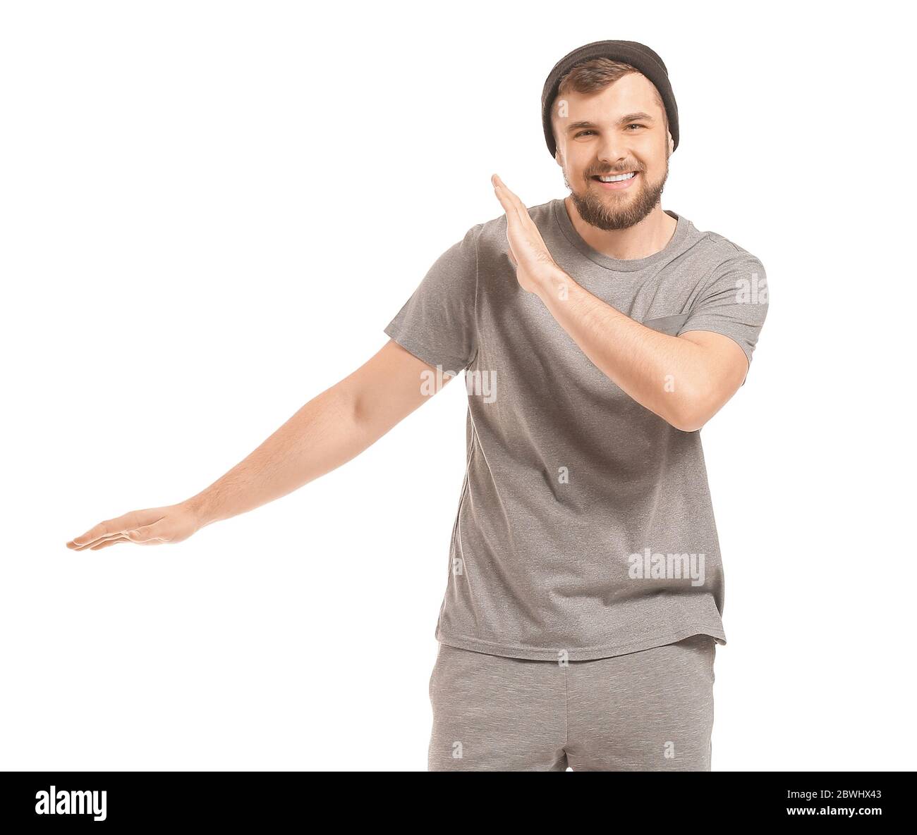 Handsome young man dancing against white background Stock Photo - Alamy