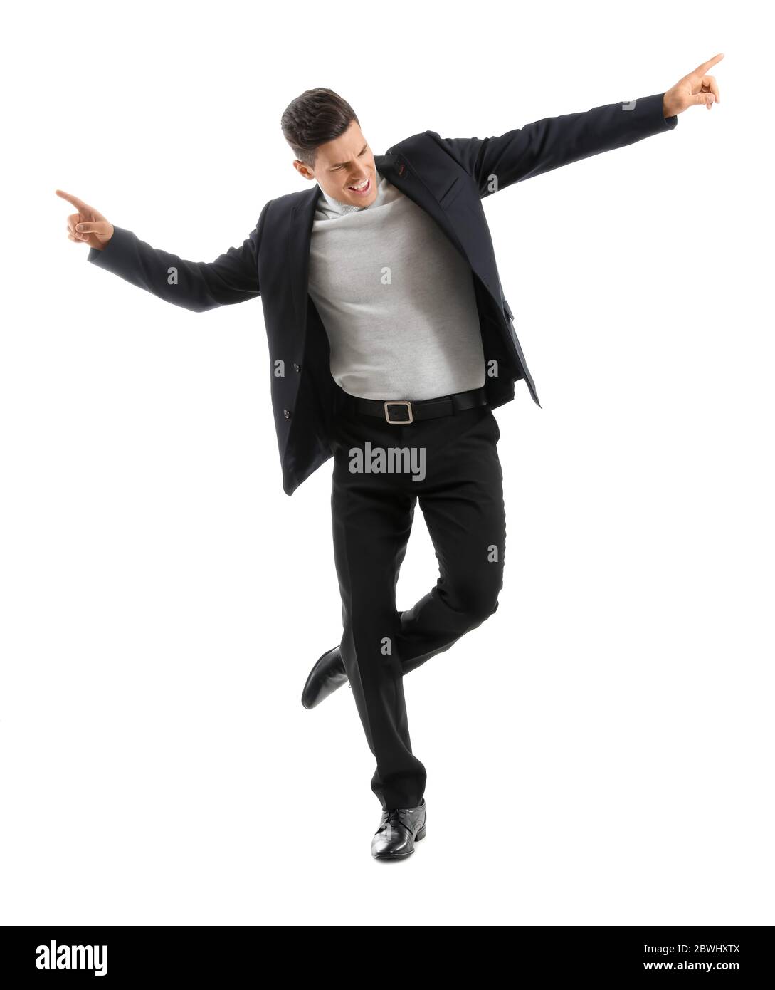 Handsome young man dancing against white background Stock Photo - Alamy