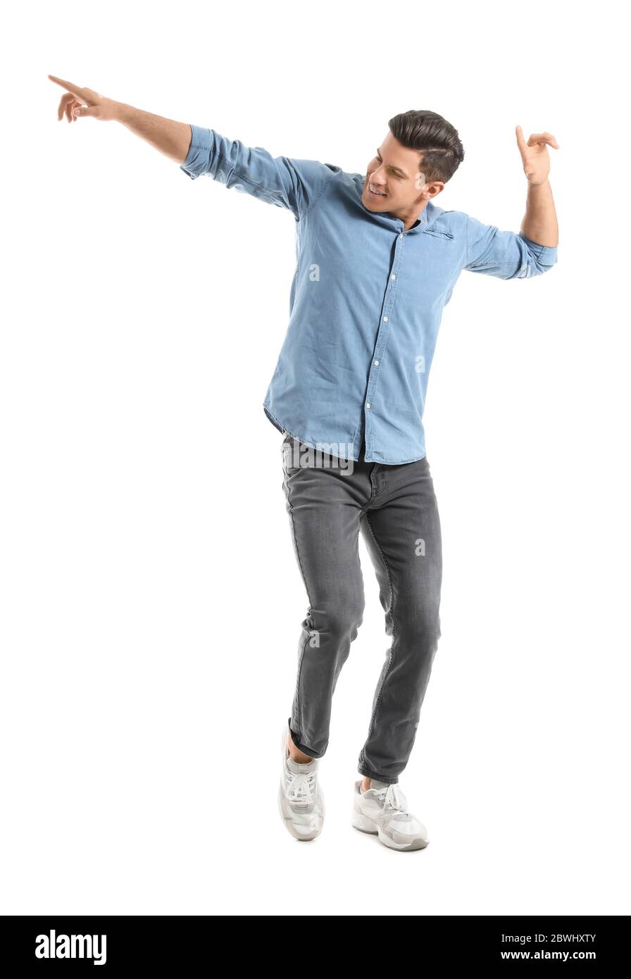 Handsome young man dancing against white background Stock Photo - Alamy