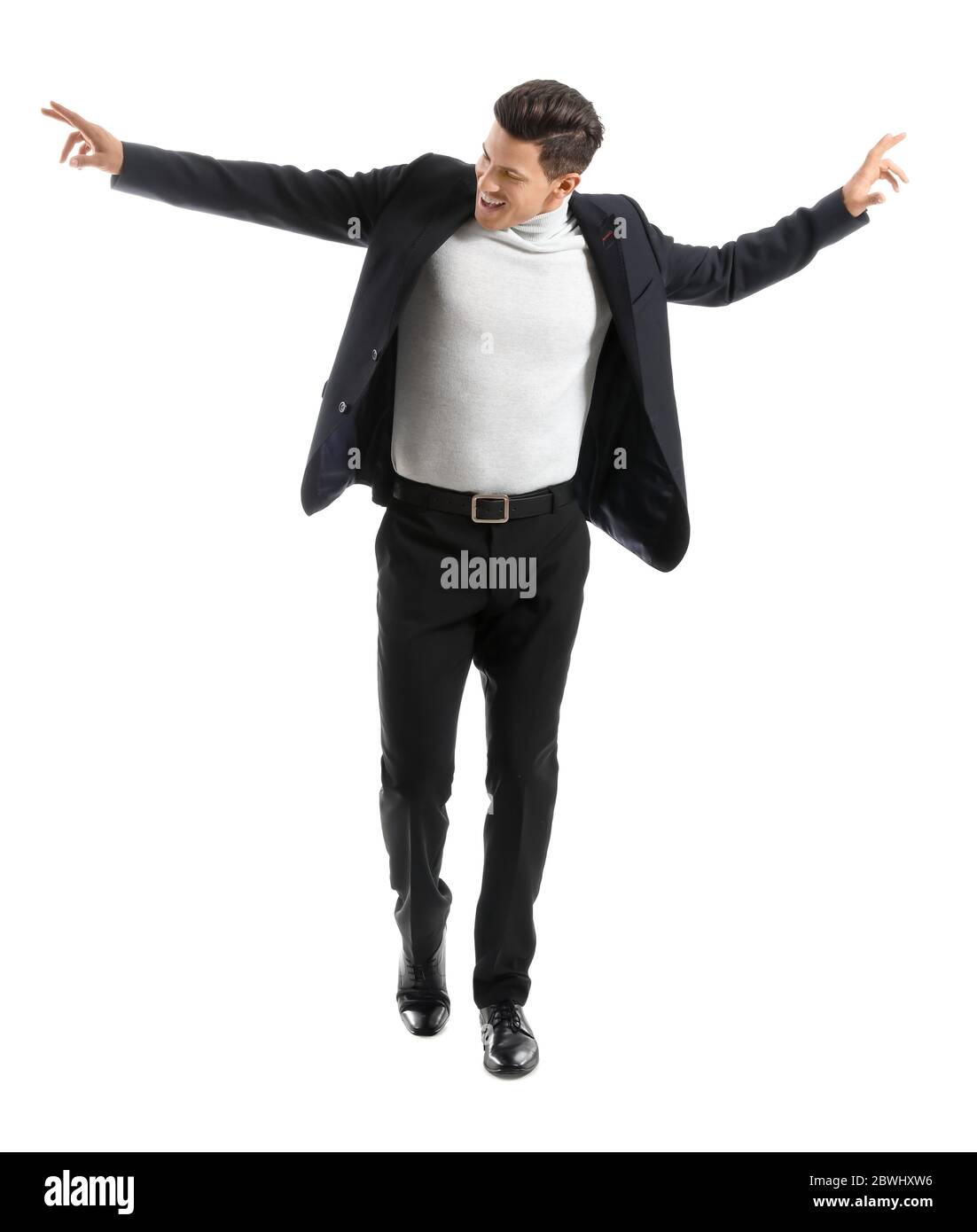 Handsome young man dancing against white background Stock Photo - Alamy