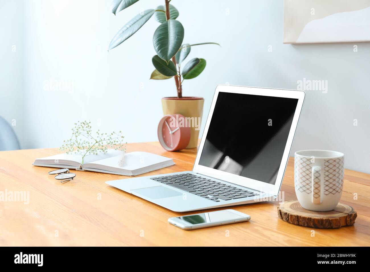 Modern laptop at workplace in room Stock Photo - Alamy