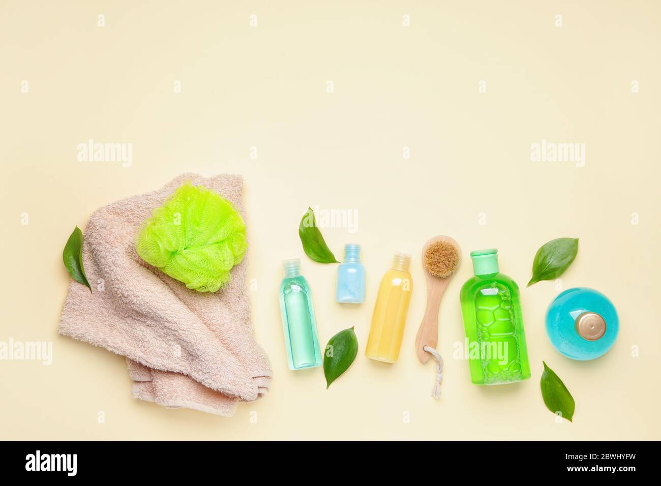 Shower gels with bath supplies on color background Stock Photo - Alamy