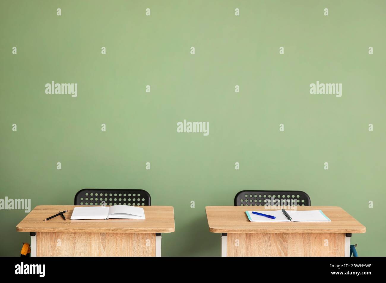 School desks near color wall in classroom Stock Photo - Alamy