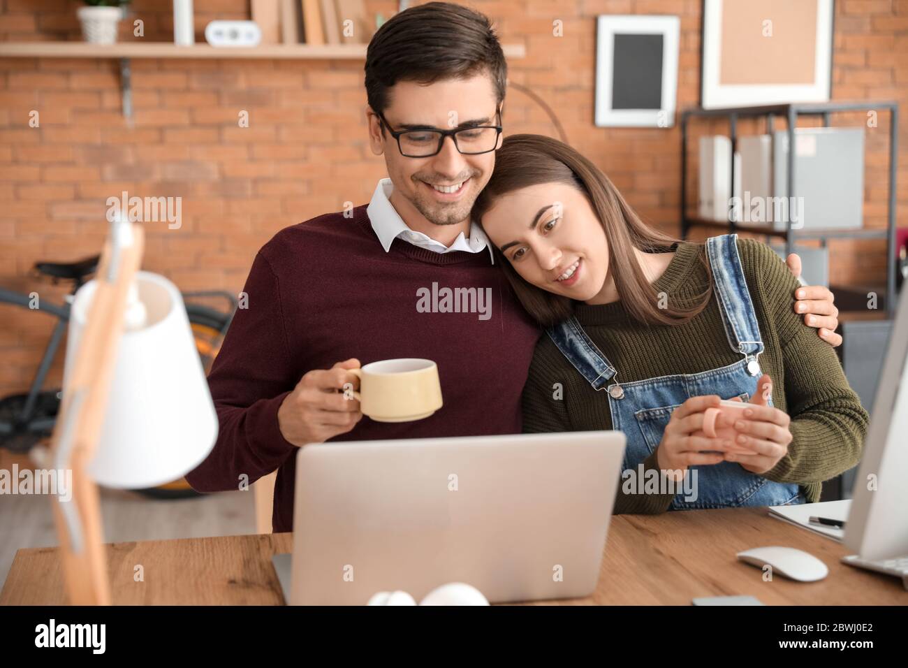 Young couple working together at home Stock Photo - Alamy