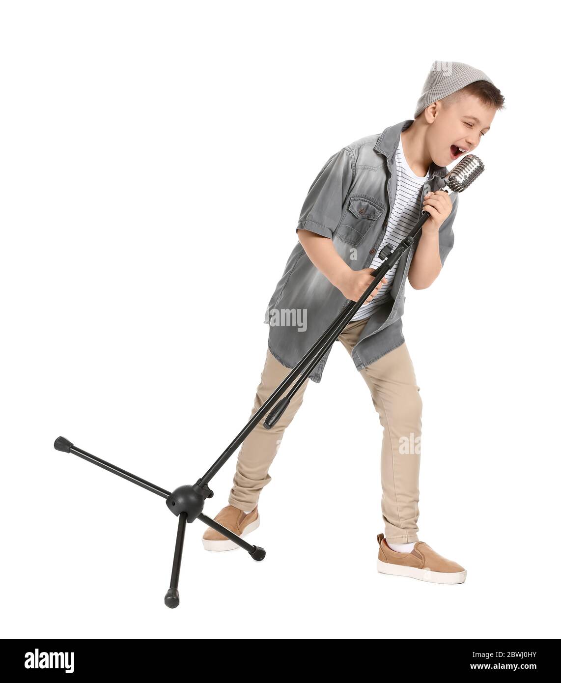 Cute little boy singing against white background Stock Photo - Alamy