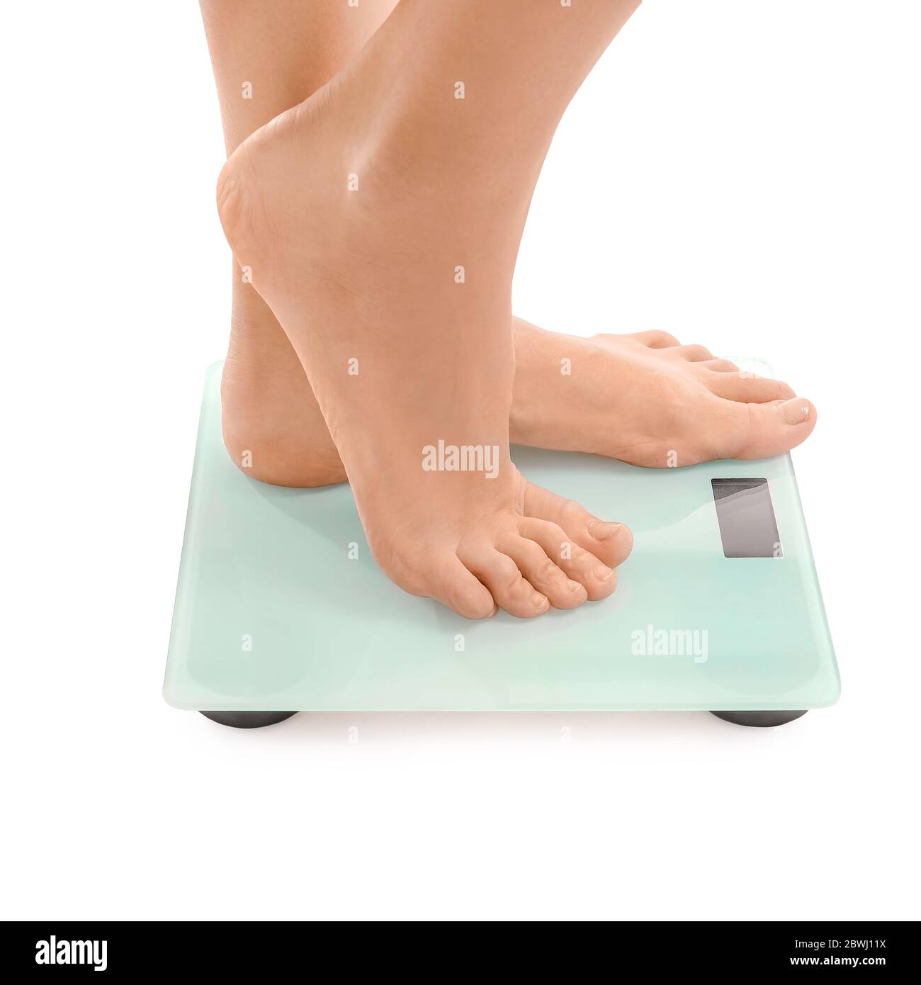Young woman measuring her weight on white background Stock Photo - Alamy