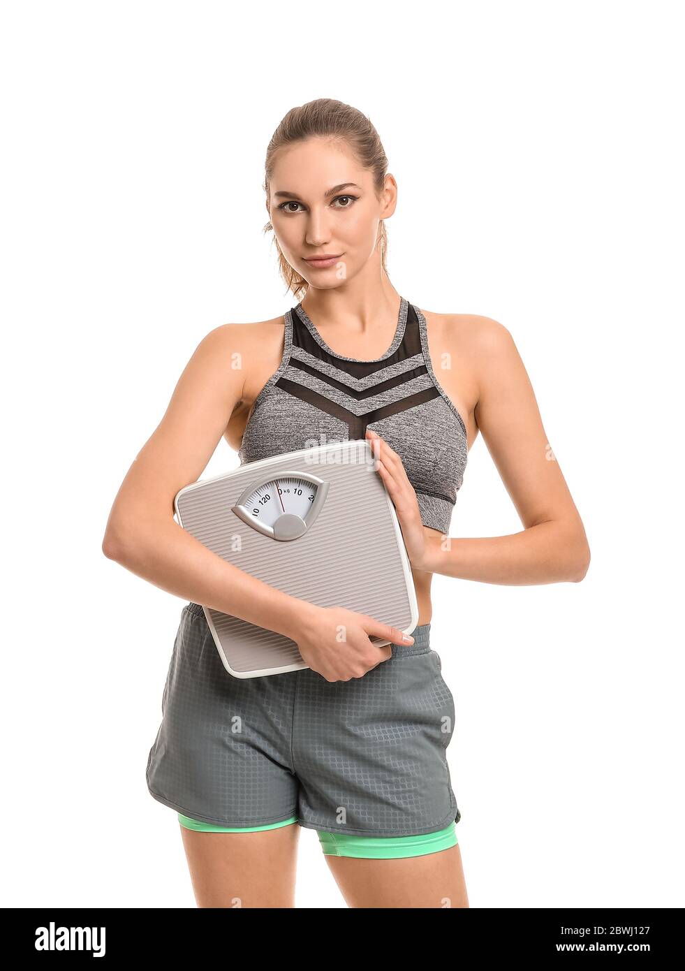 Young woman with weight scales on white background Stock Photo - Alamy