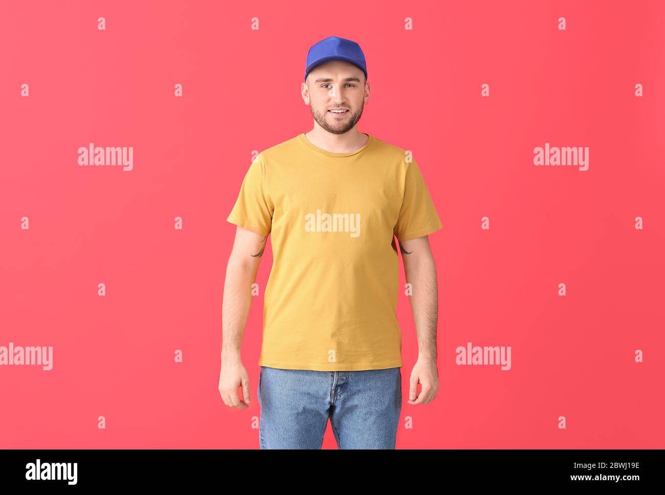 Handsome man in stylish cap on color background Stock Photo - Alamy