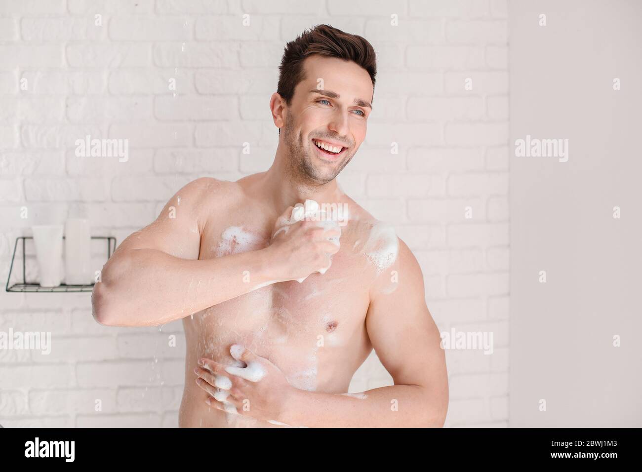 Handsome man taking shower at home Stock Photo - Alamy