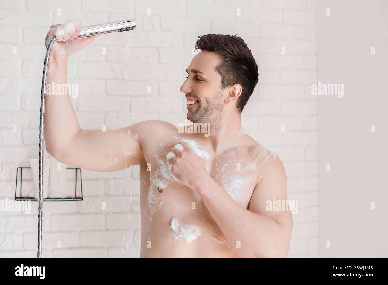 Handsome young man taking shower hi-res stock photography and images - Alamy