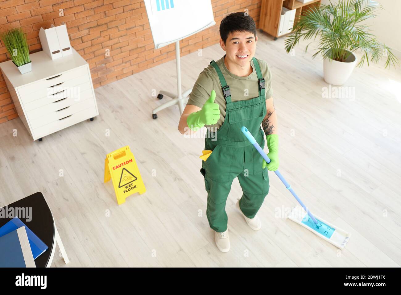 Portrait of male Asian janitor in office Stock Photo - Alamy