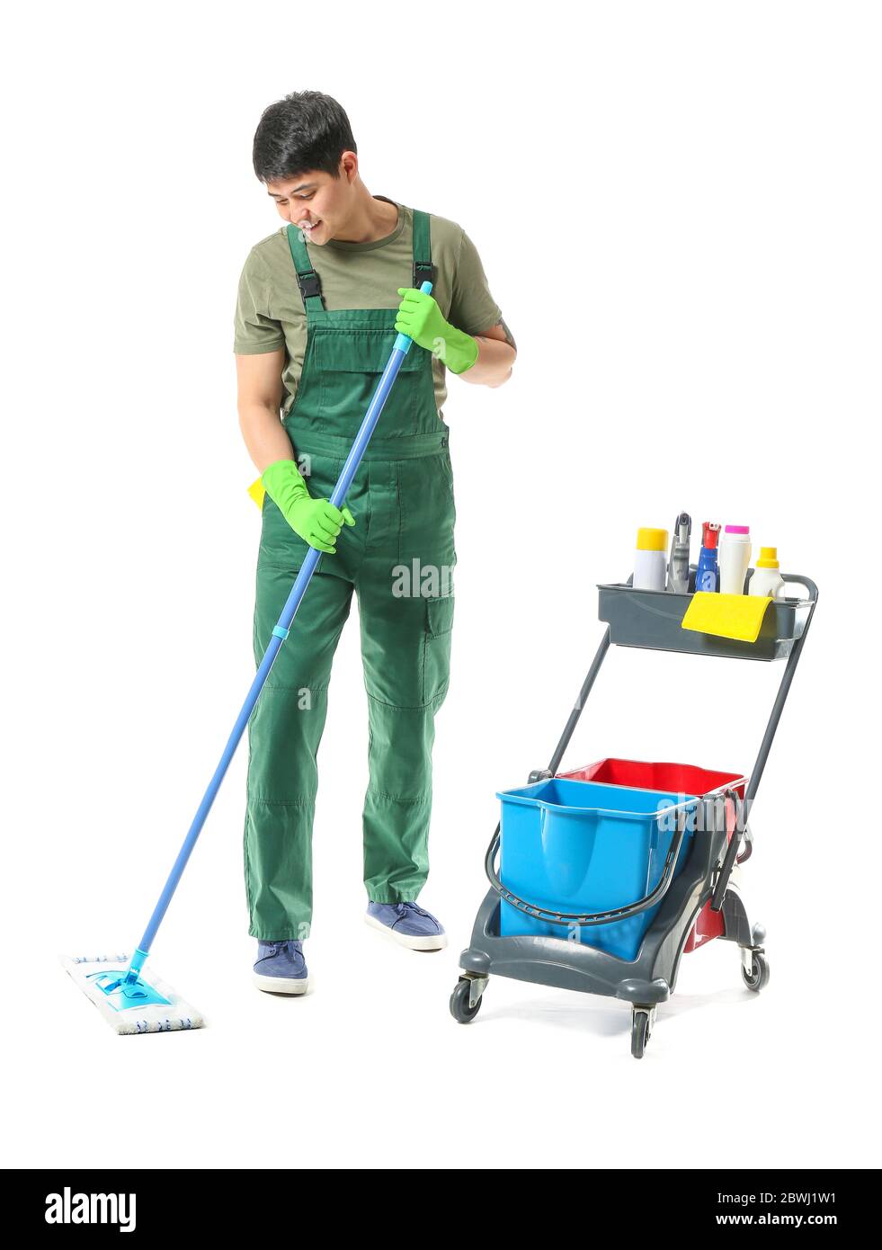 Male janitor with cleaning supplies on white background Stock Photo - Alamy