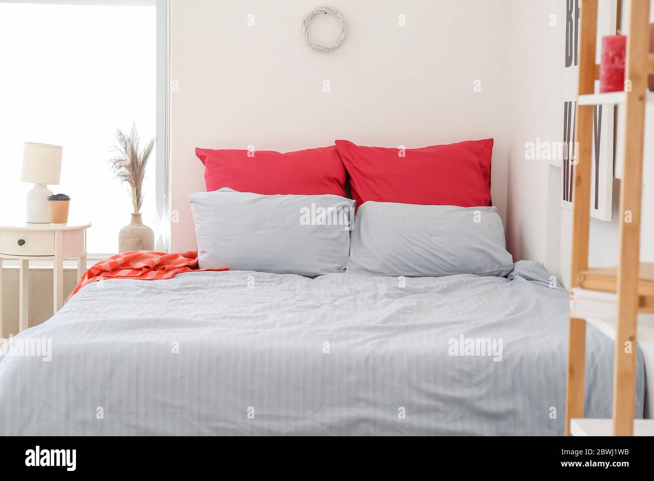 Big comfortable bed in interior of room Stock Photo - Alamy