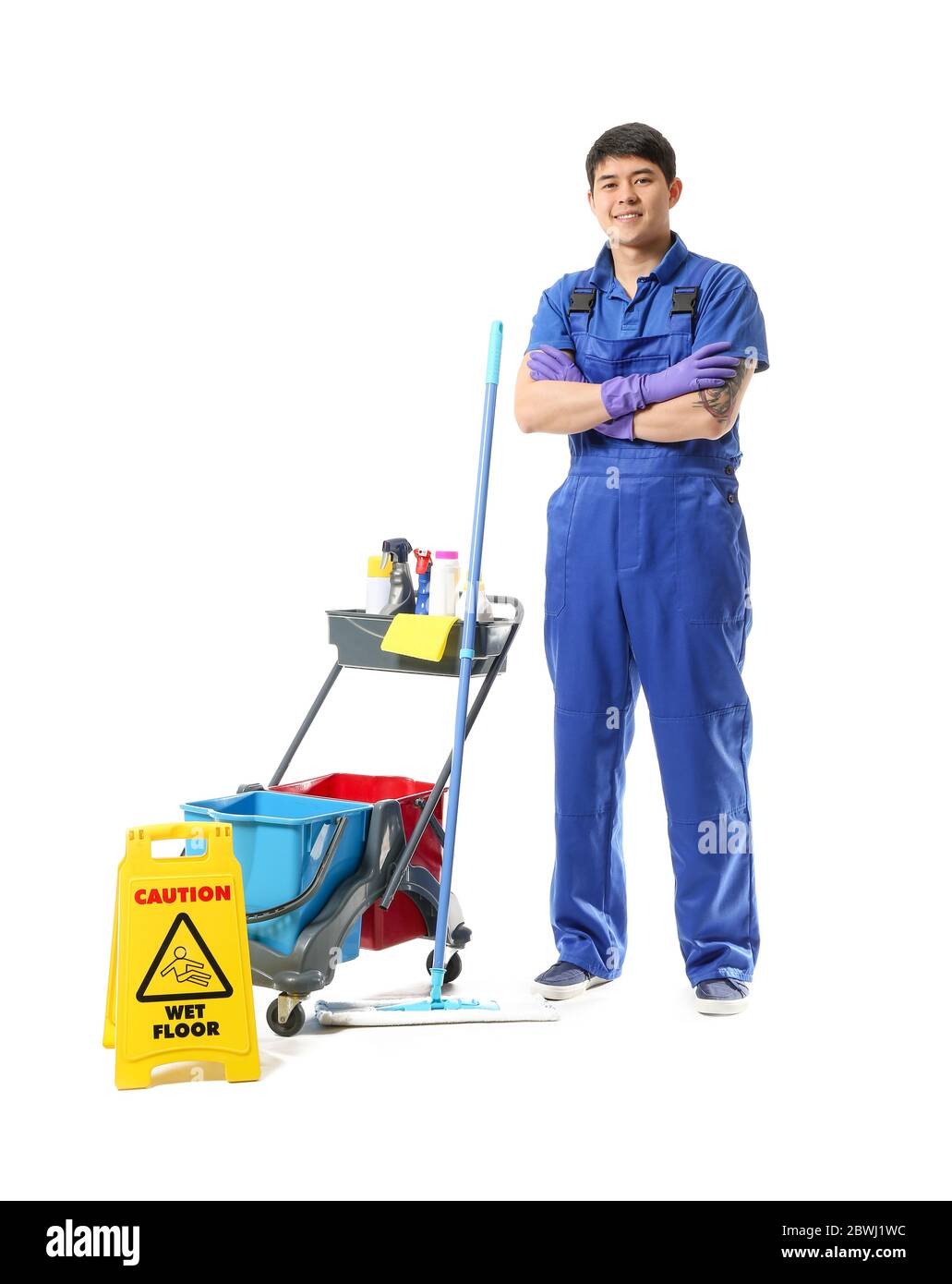 Male janitor with cleaning supplies on white background Stock Photo - Alamy
