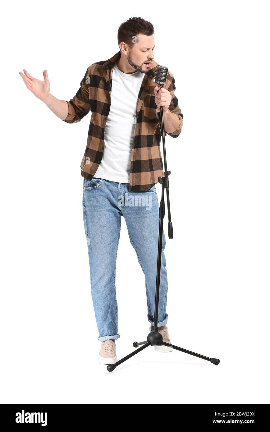 Handsome man singing against white background Stock Photo - Alamy
