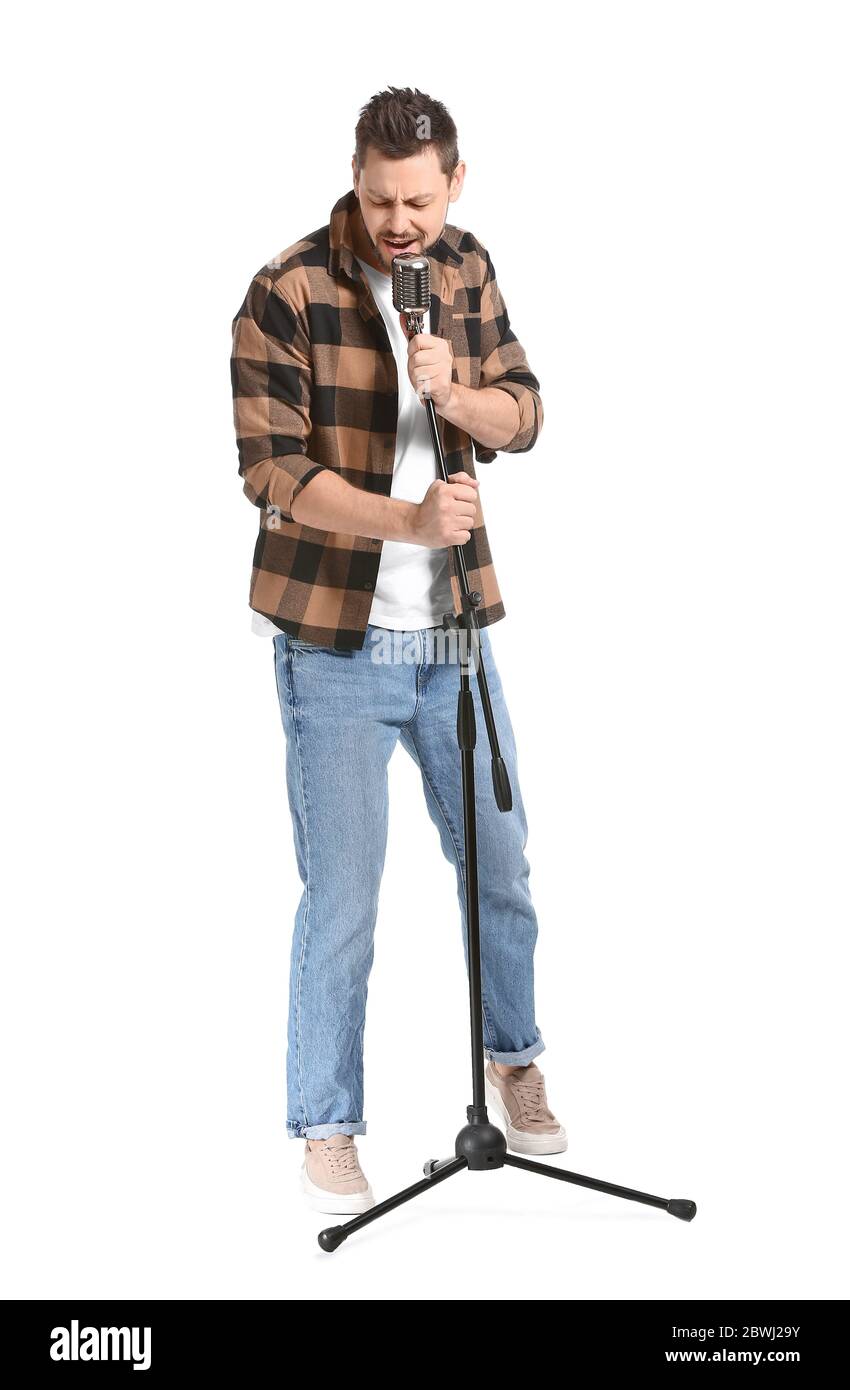 Handsome man singing against white background Stock Photo - Alamy
