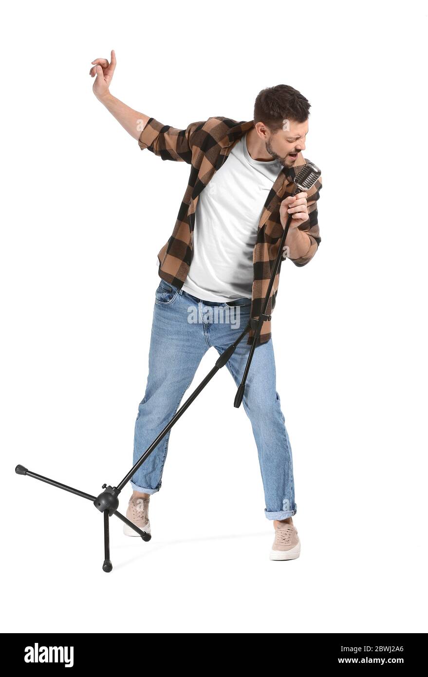Handsome man singing against white background Stock Photo - Alamy