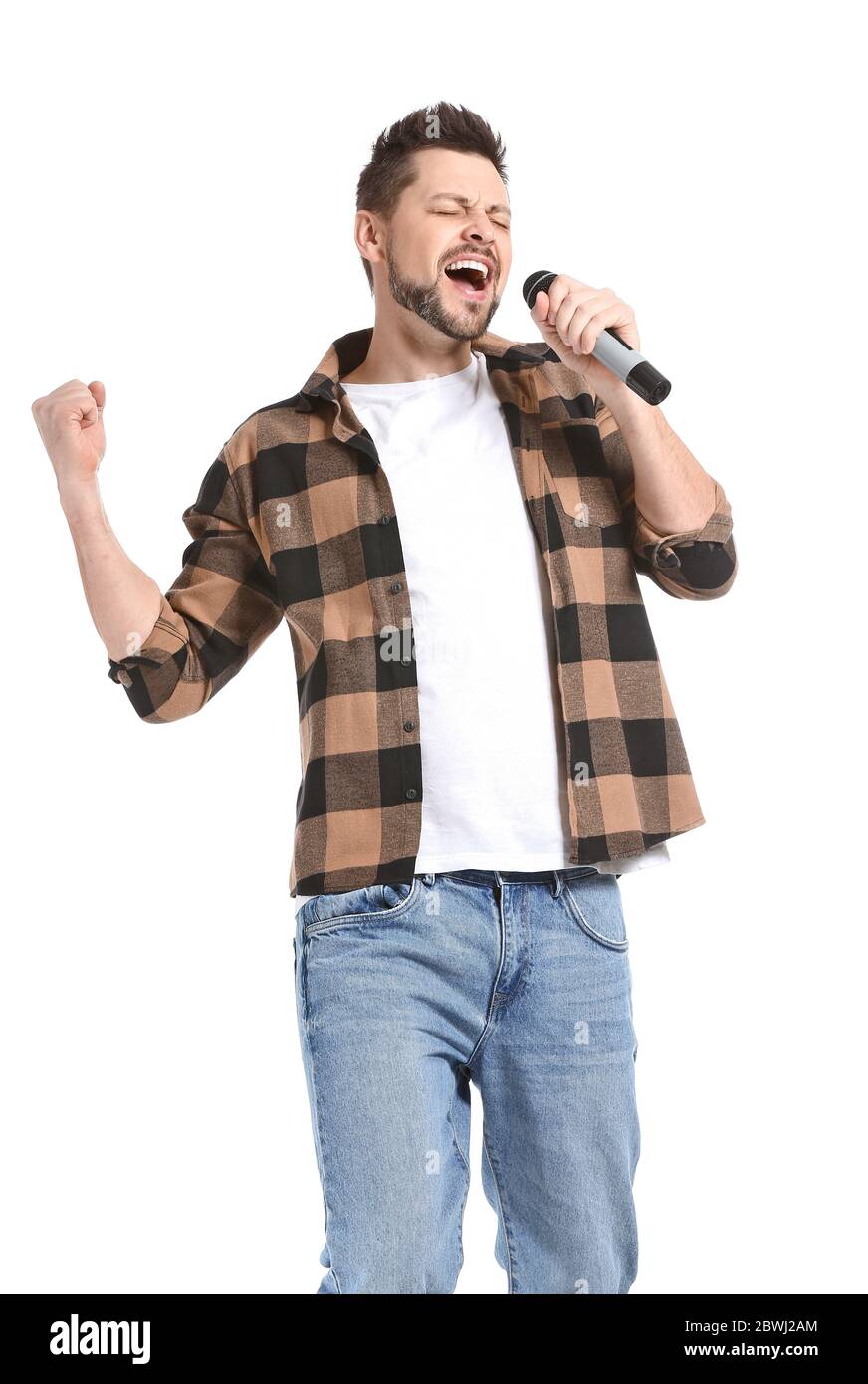 Handsome man singing against white background Stock Photo - Alamy