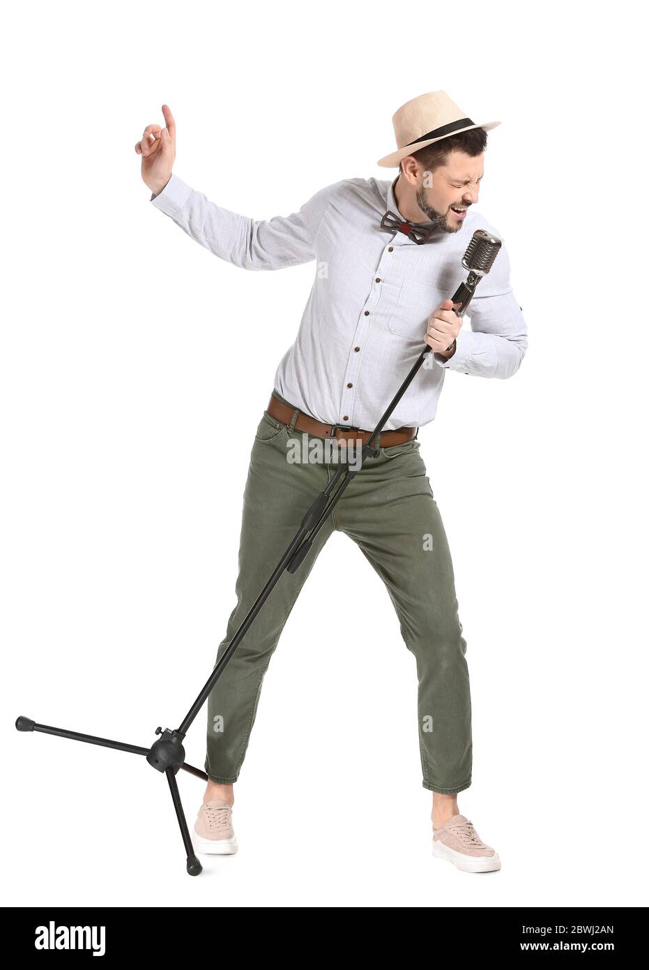 Handsome man singing against white background Stock Photo - Alamy