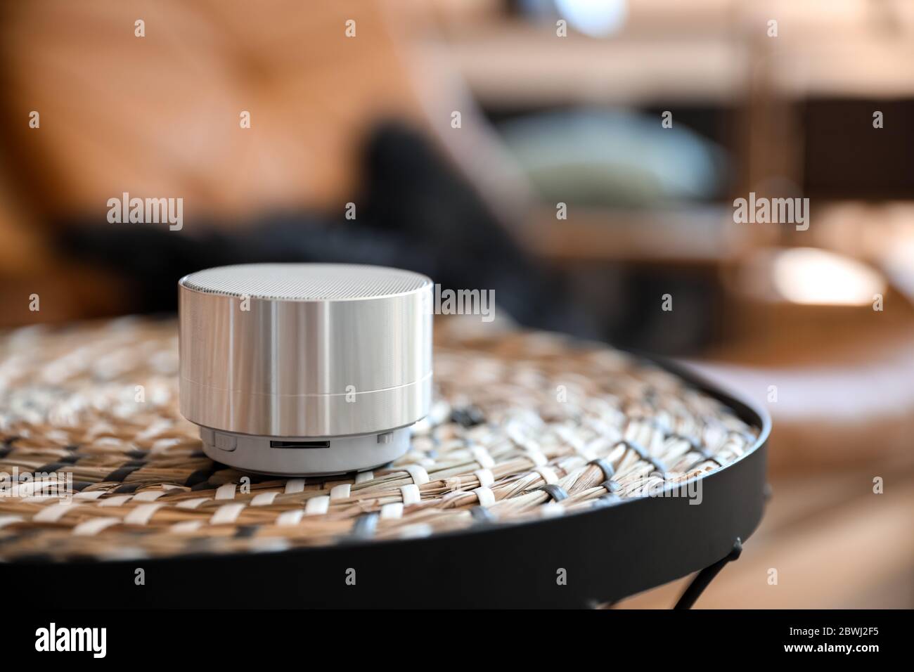Smart home assistant device on table in room Stock Photo - Alamy