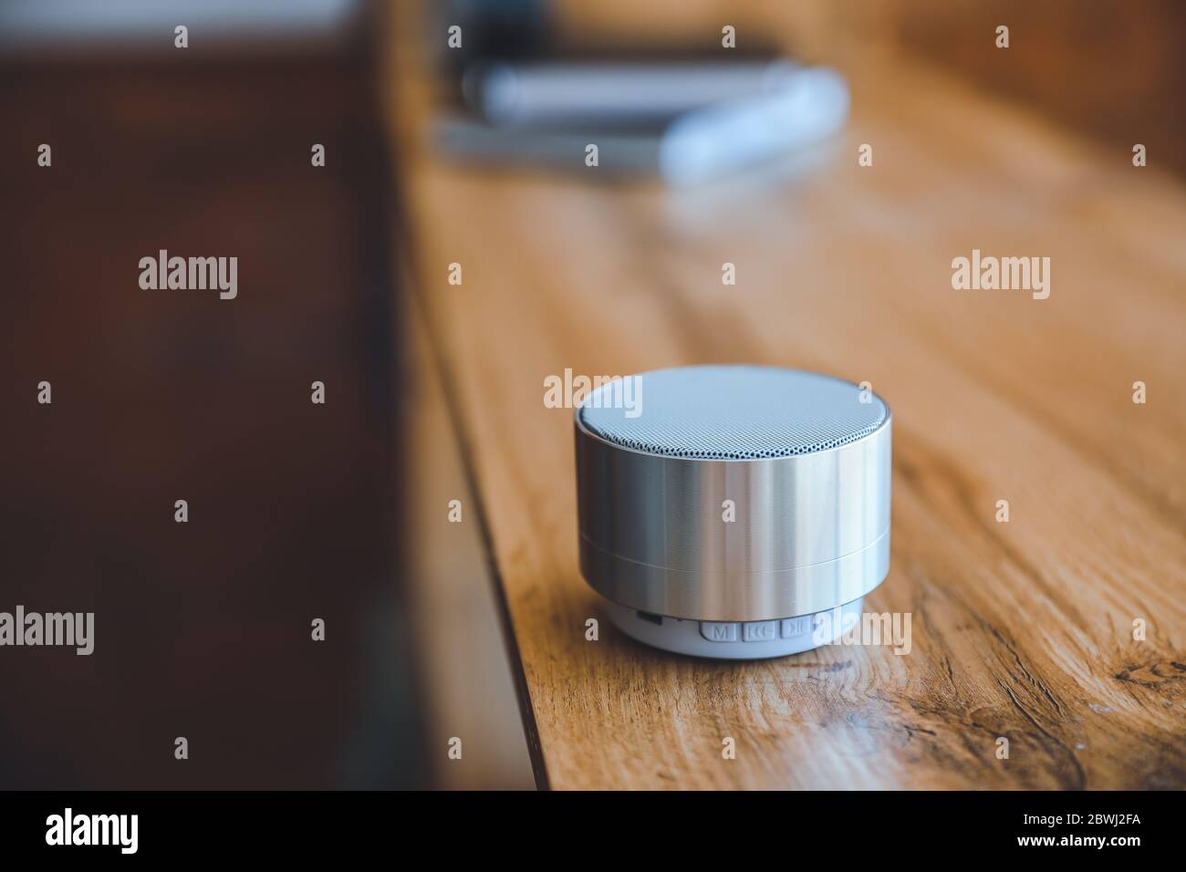 Smart home assistant device on table in room Stock Photo - Alamy