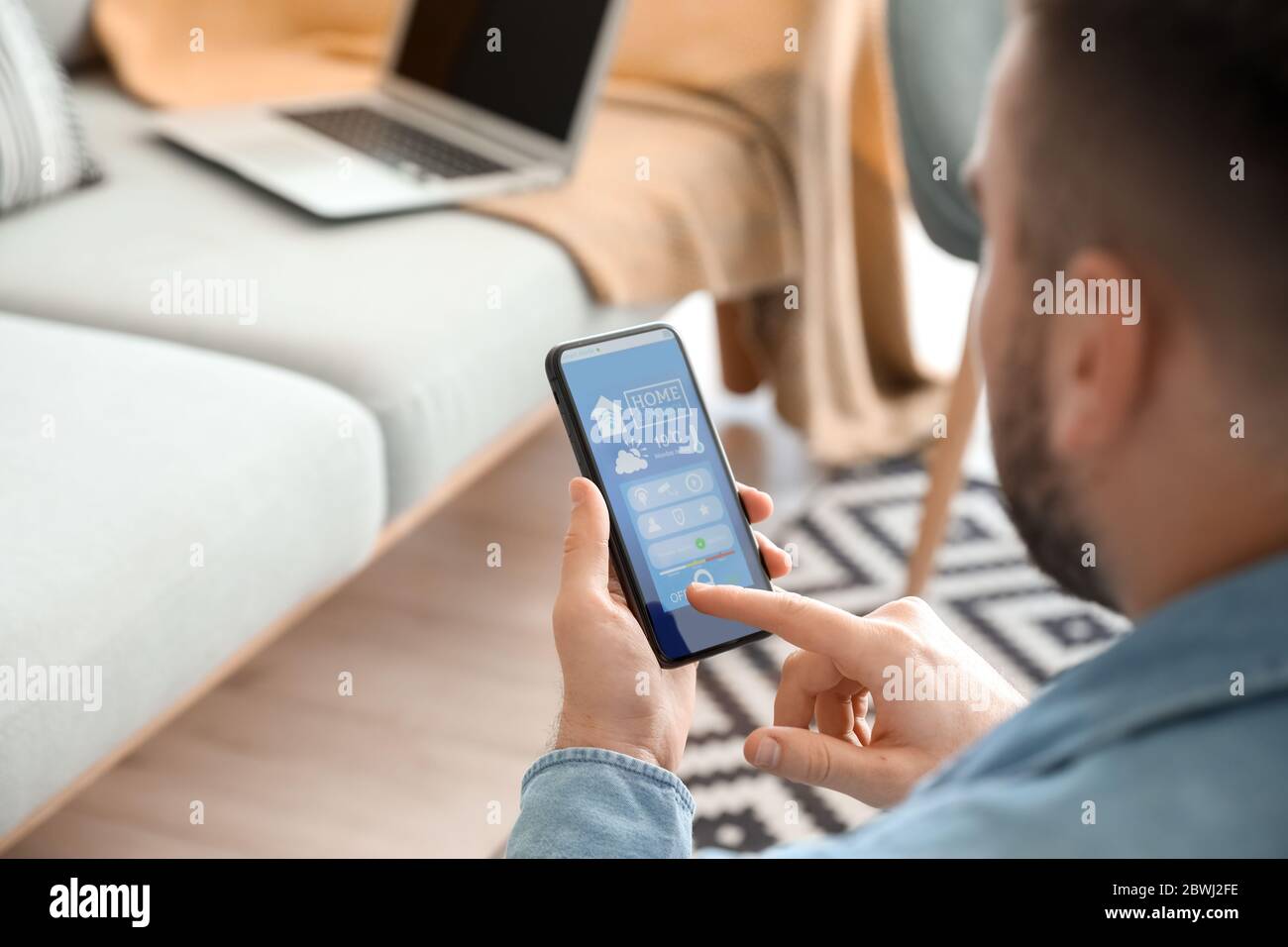 Man using application of smart home automation Stock Photo - Alamy
