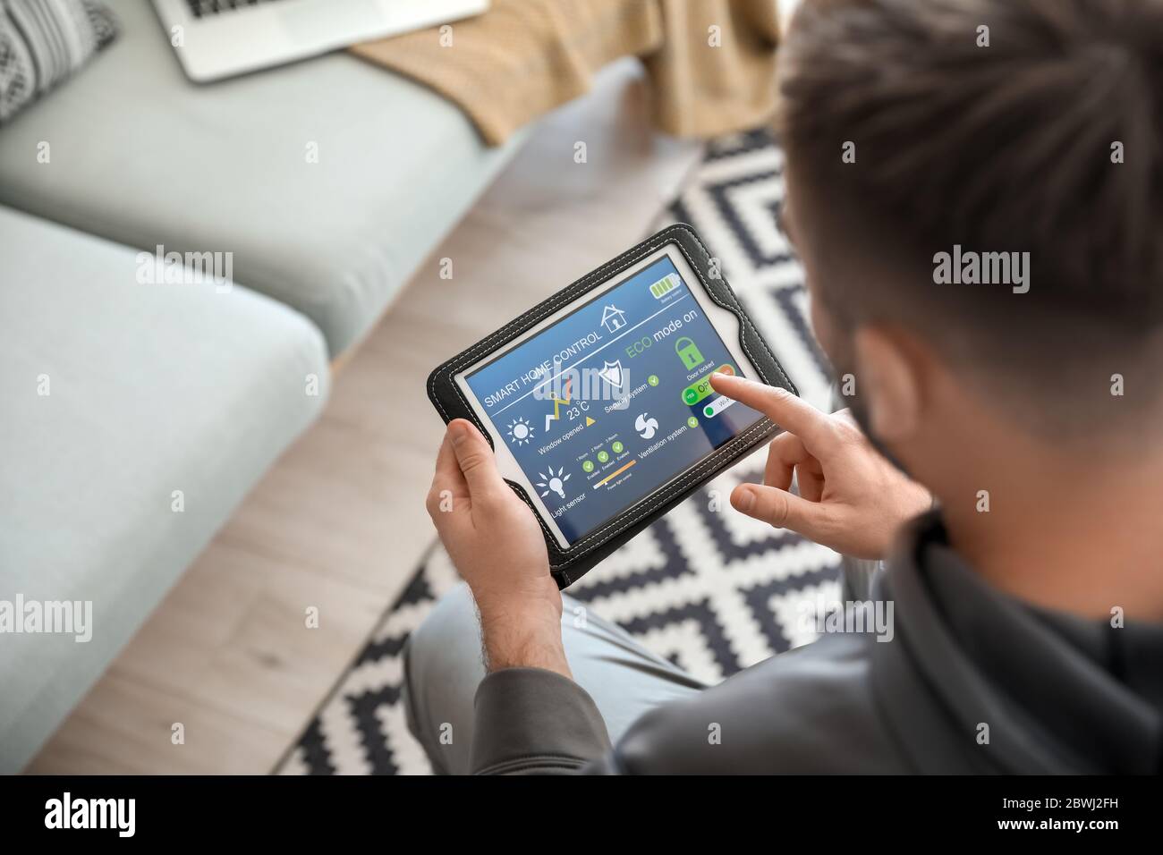 Man using application of smart home automation Stock Photo - Alamy