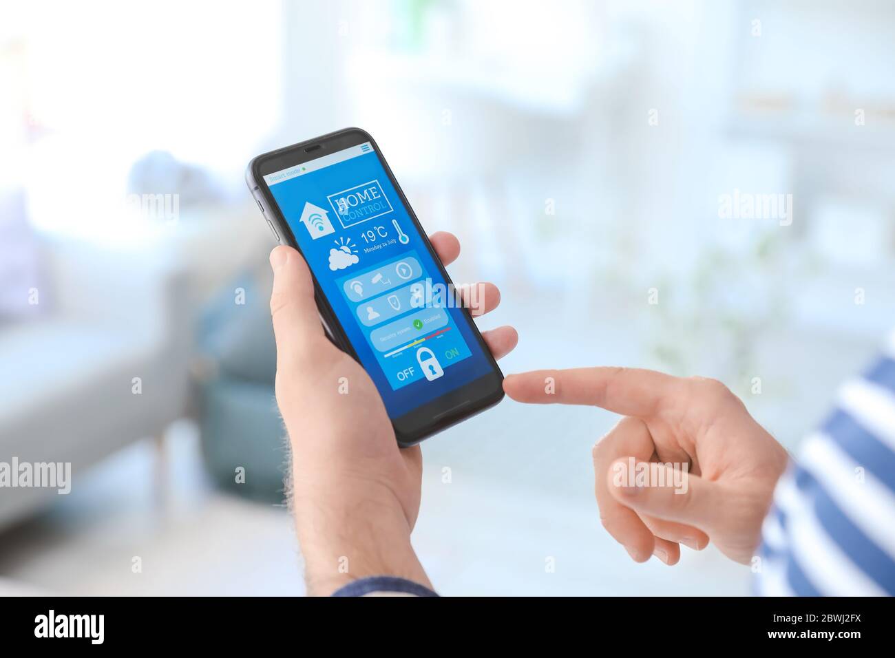 Man using application of smart home automation Stock Photo - Alamy