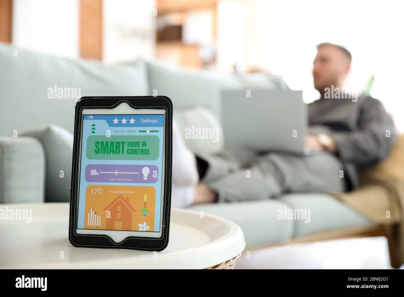Tablet computer with application of smart home automation on table in ...